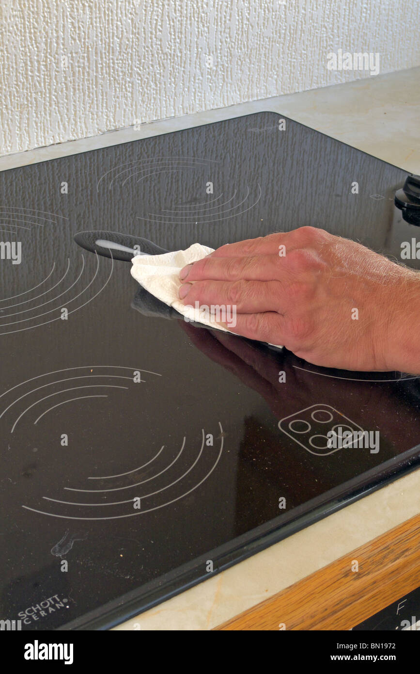 Man Cleaning Halogen Hob in a Domestic Kitchen Setting MODEL RELEASED ...