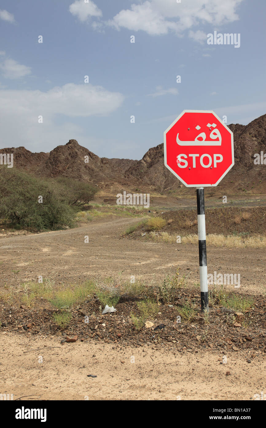 landscape and Arabian stop sign in the desert at Sultanate of Oman ...