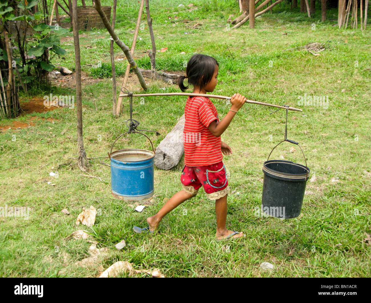 girl carrying water at Kompong Phluk village, Tonle Sap Lake, Cambodia ...