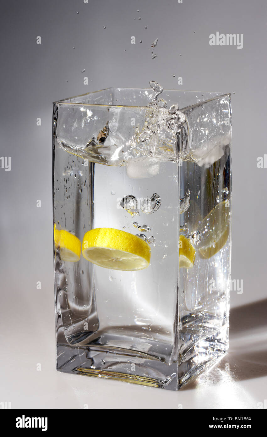 A lemon being dropped into a jar of water Stock Photo - Alamy