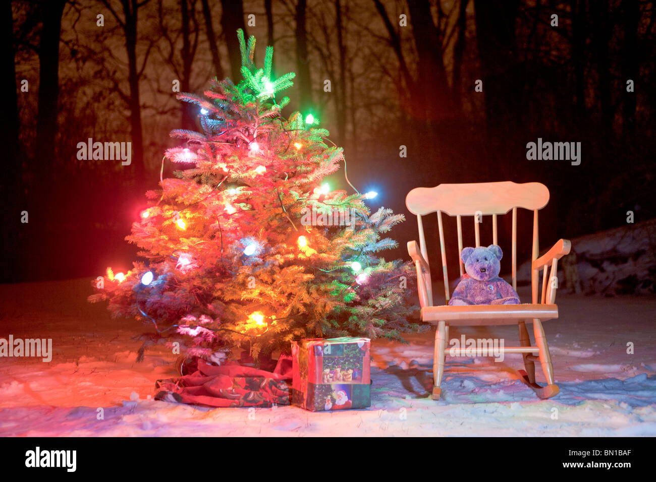 A Christmas Tree, rocking chair, teddy bear and presents Stock Photo ...