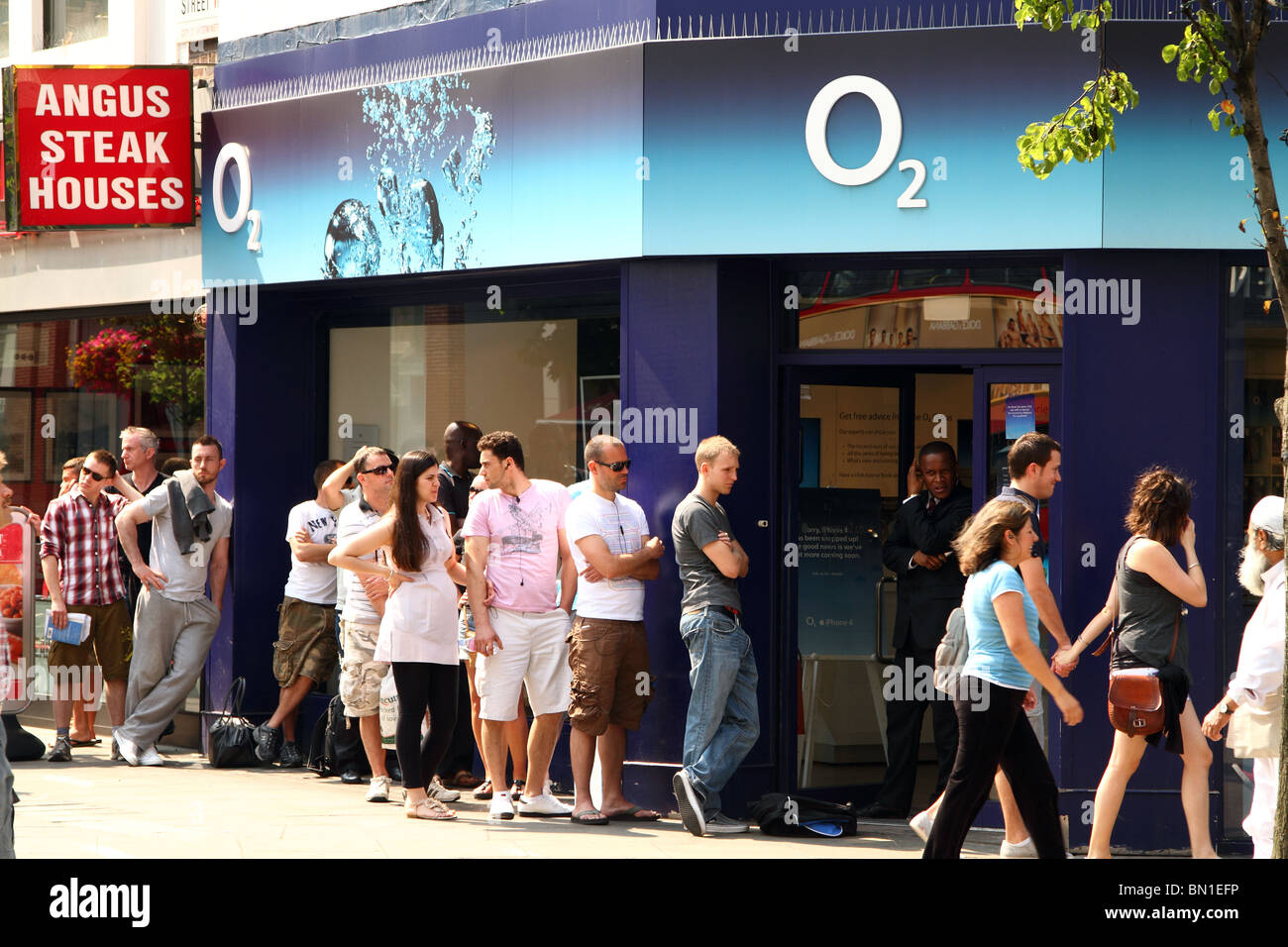 People queue outside the O2 store in Oxford Street, the day after the ...