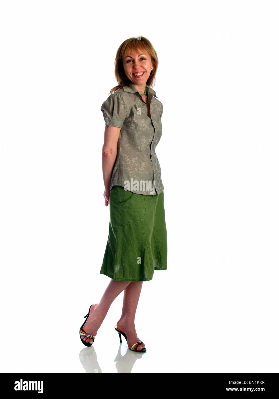 Attractive mid adult woman in casual dress on white background Stock ...