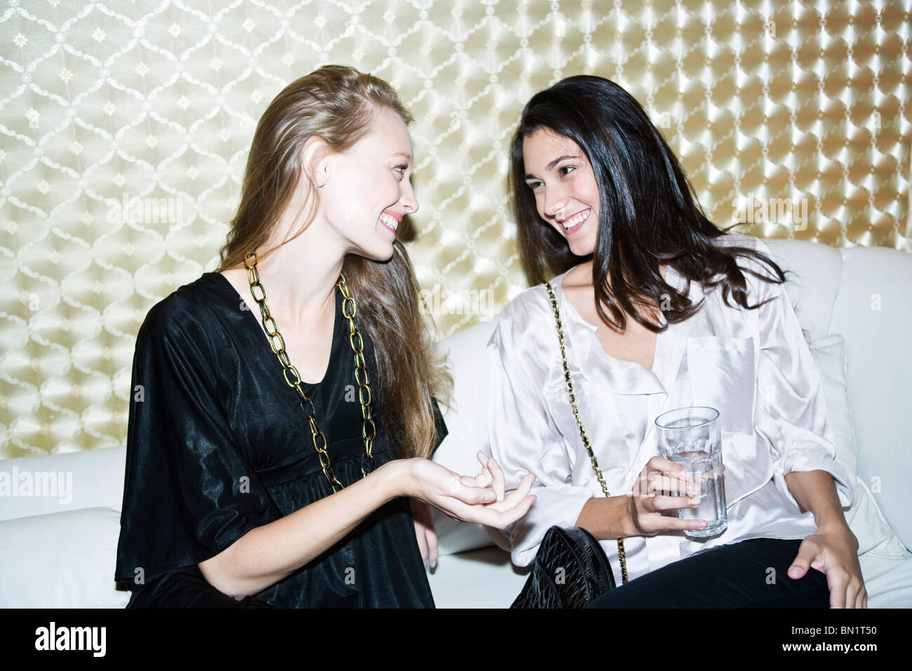 Friends chatting at nightclub Stock Photo - Alamy