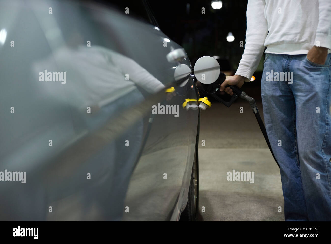 Man refueling car night hi-res stock photography and images - Alamy