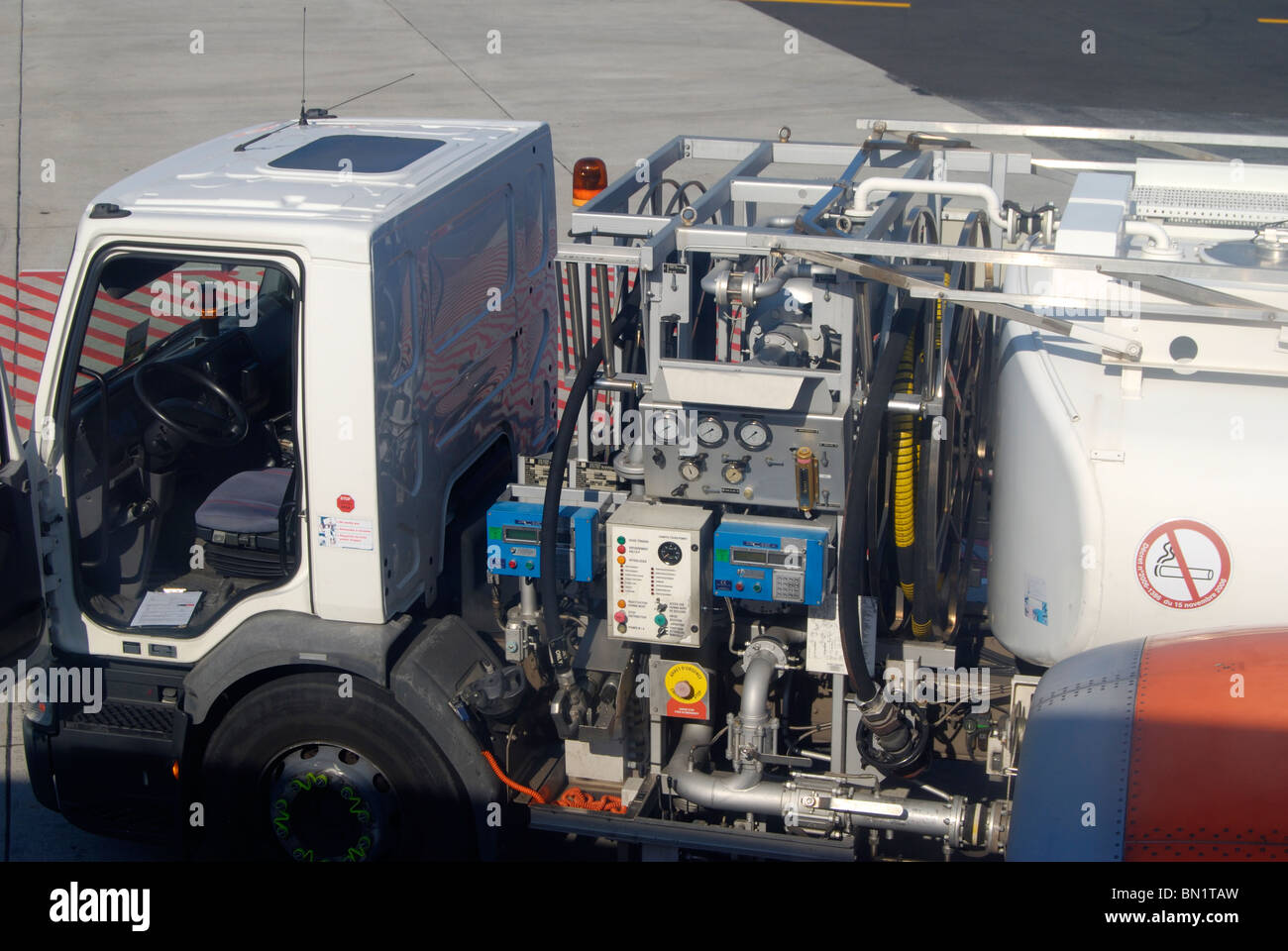 Aviation fuel tanker, delivering fuel to airliner on stand at Nice ...