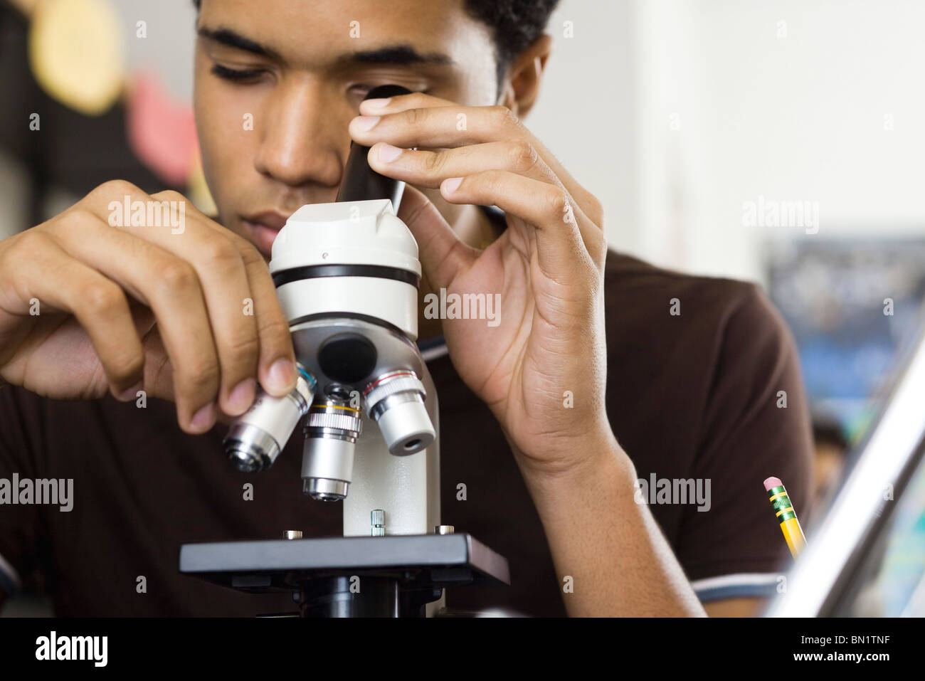 Student looking through microscope Stock Photo - Alamy Student looking through microscope Stock Photo - Alamy