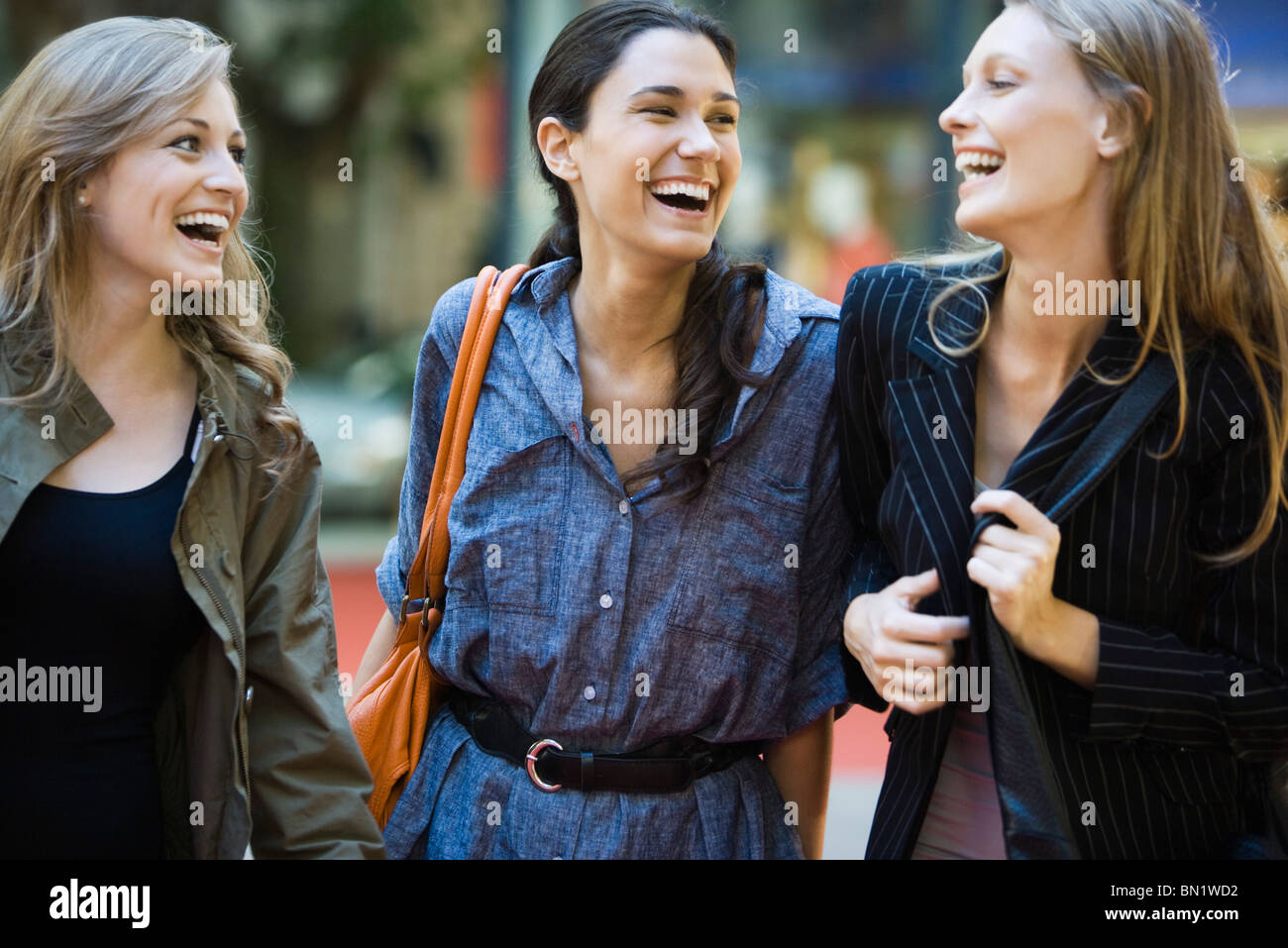 Friends laughing together Stock Photo - Alamy