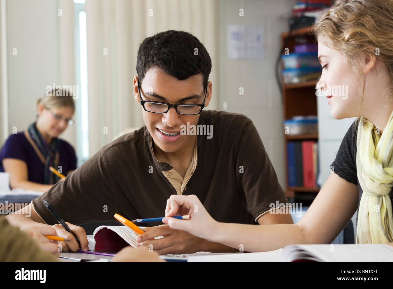 Classmates working on mathematics assignment together Stock Photo - Alamy