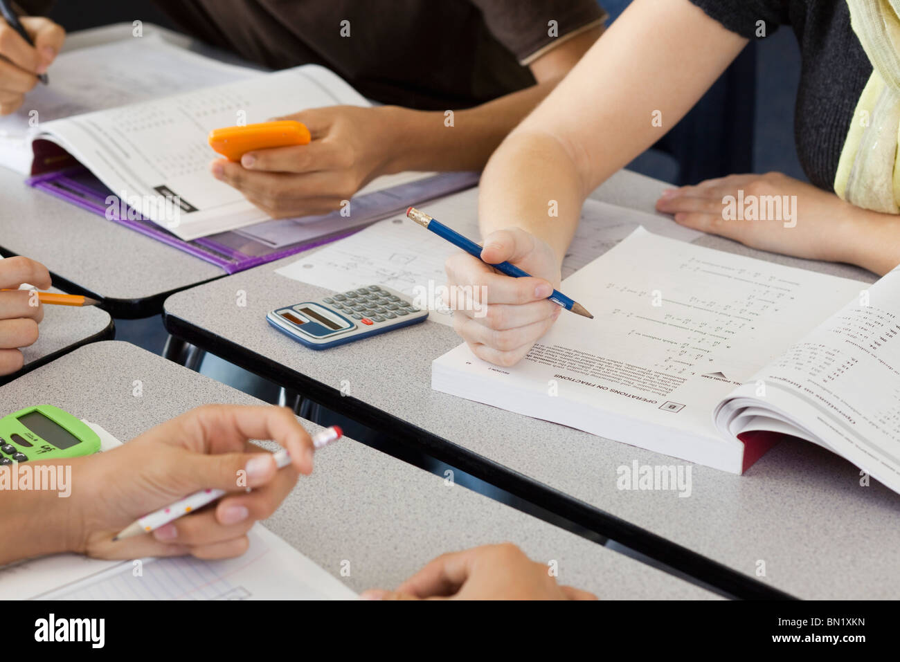 Students completing mathematics assignment together, cropped Stock ...