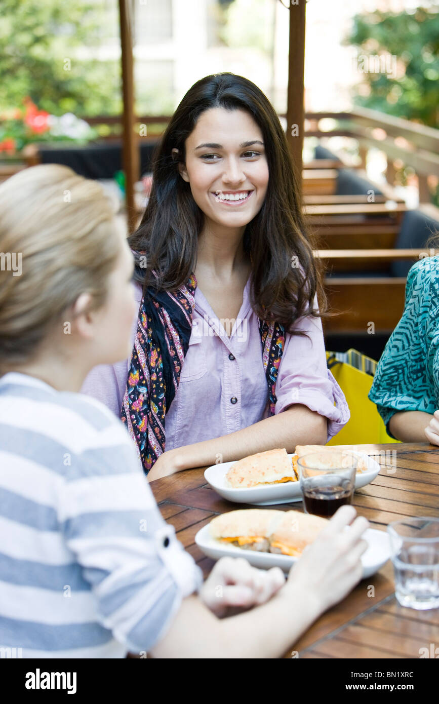 Young woman having lunch with friend Stock Photo - Alamy
