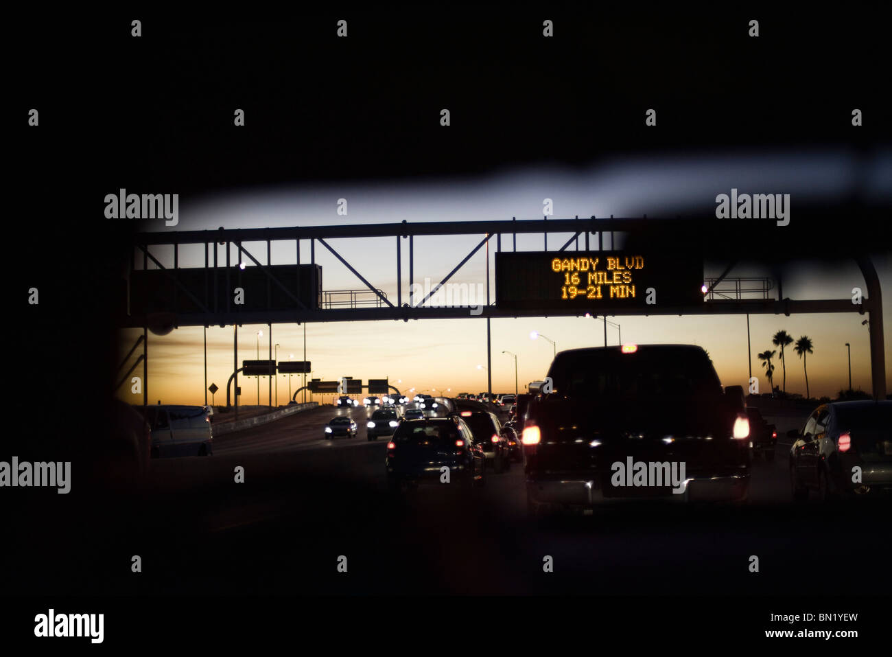 Driving in traffic at sunset Stock Photo - Alamy