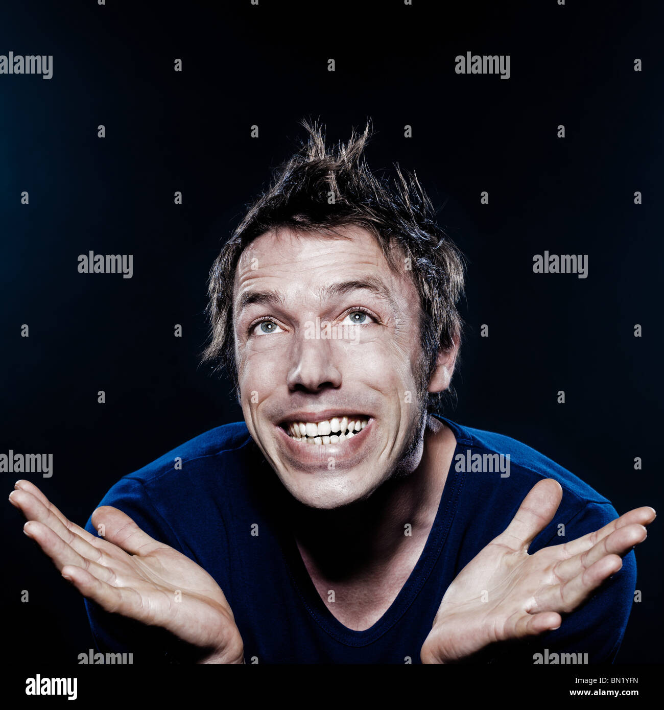 studio portrait on black background of a funny expressive caucasian man ...