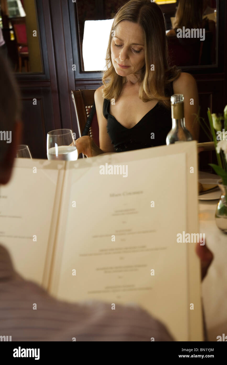 Couple reading menus in restaurant Stock Photo - Alamy