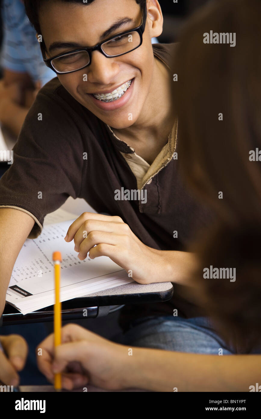 Teen boy helping classmate Stock Photo - Alamy