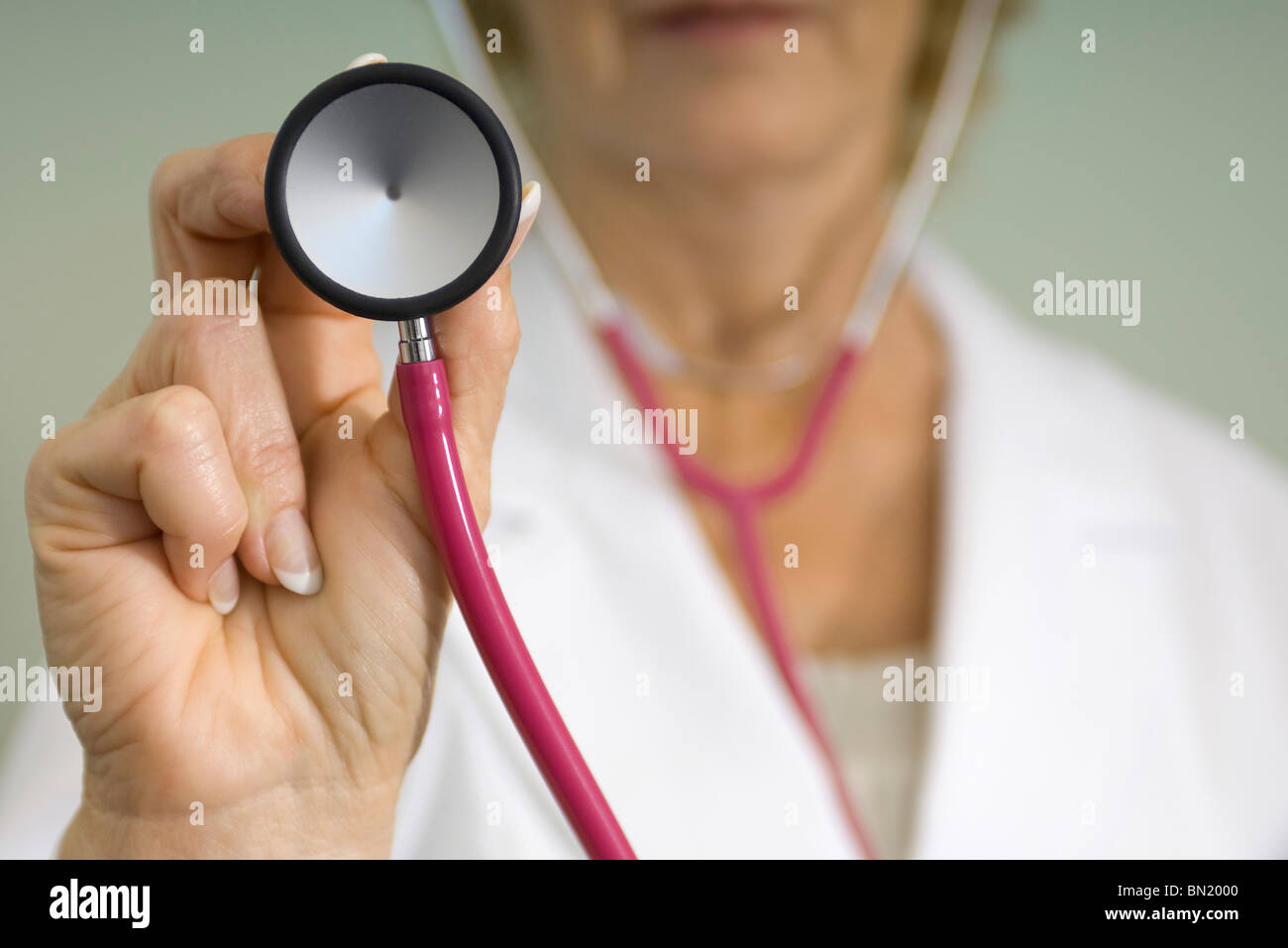 Doctor holding stethoscope and listens hi-res stock photography and ...