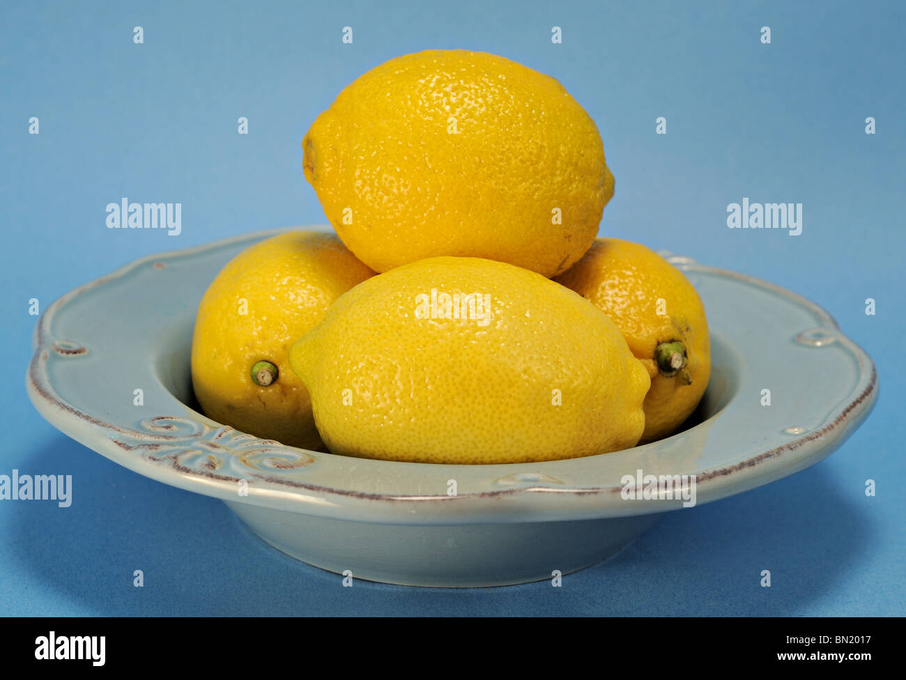 Still life of lemons in a blue bowl Stock Photo - Alamy