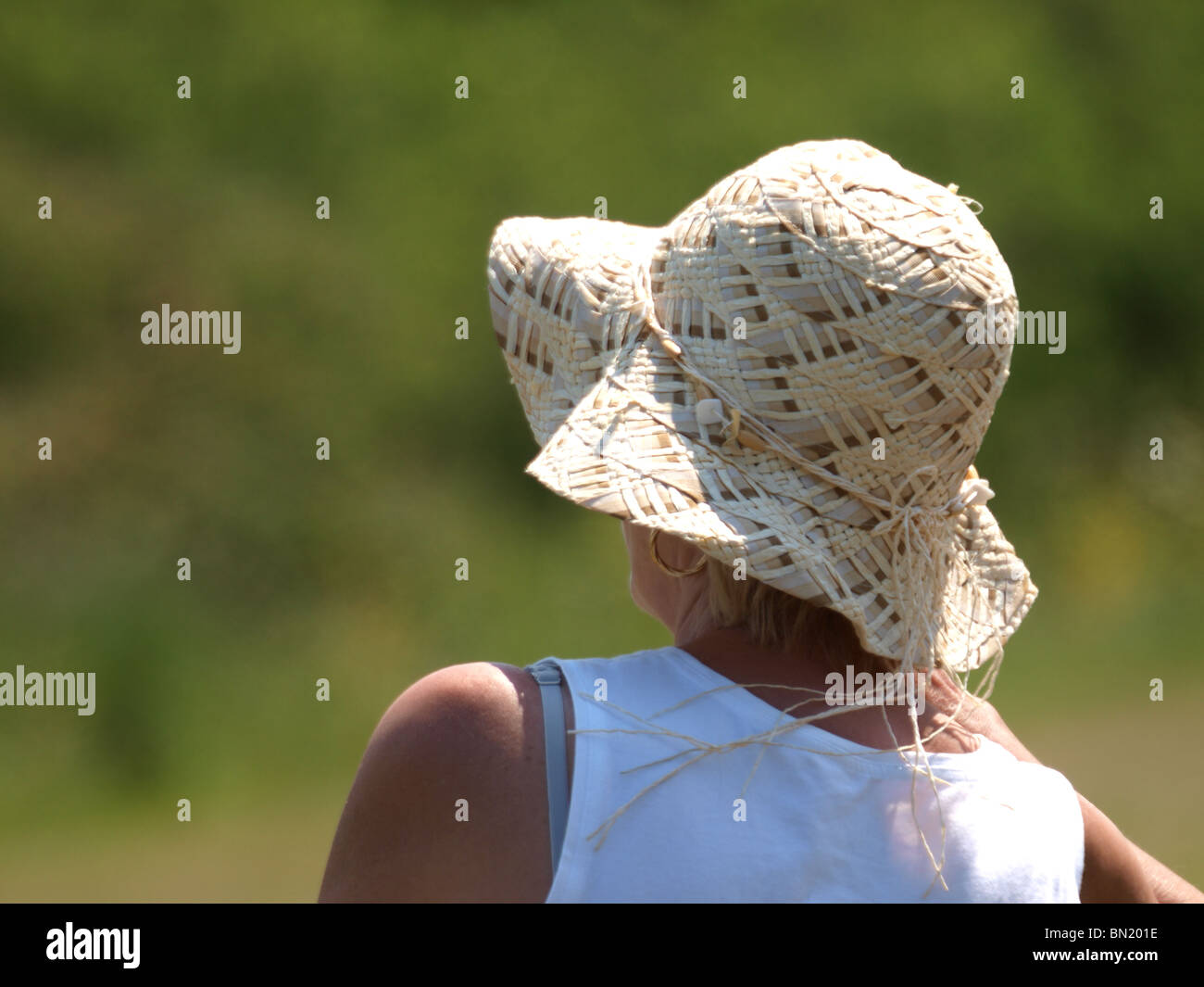 Woman wearing a straw hat, UK Stock Photo - Alamy