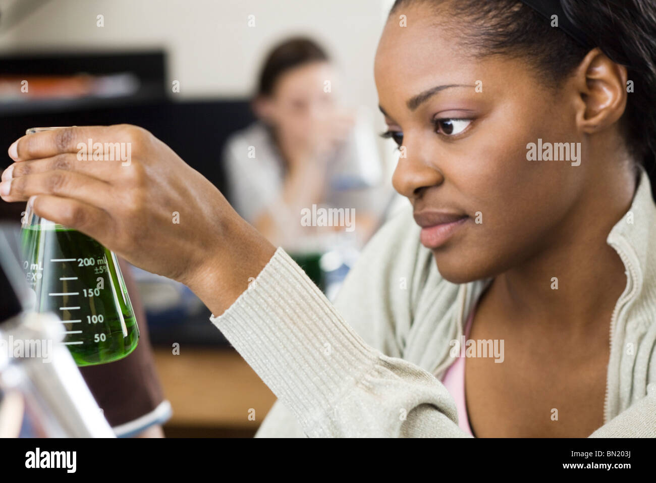 Student conducting experiment in chemistry class Stock Photo - Alamy