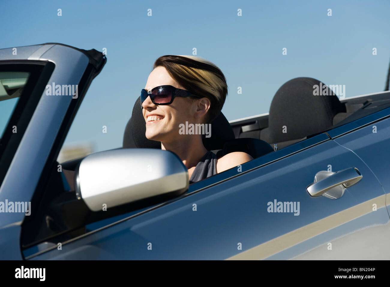 Woman driving convertible Stock Photo - Alamy