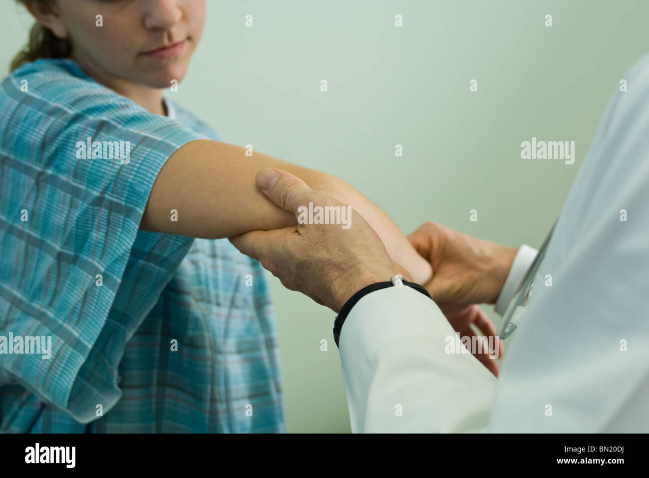 Doctor examining patient's arm Stock Photo - Alamy