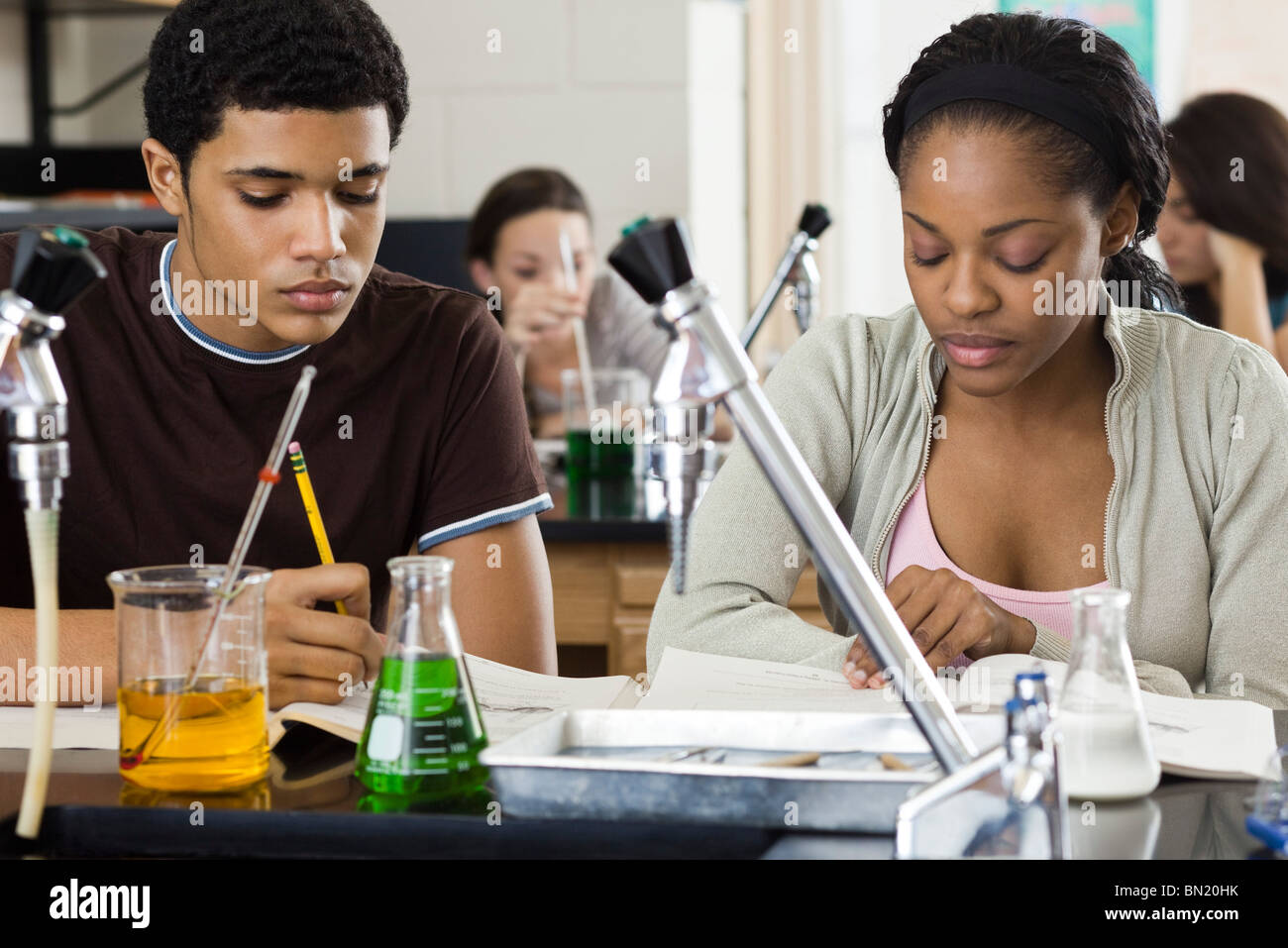 Students completing assignment in chemistry class Stock Photo - Alamy