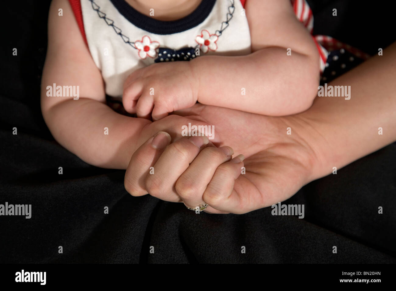 A baby's hand in her mother's hand Stock Photo - Alamy