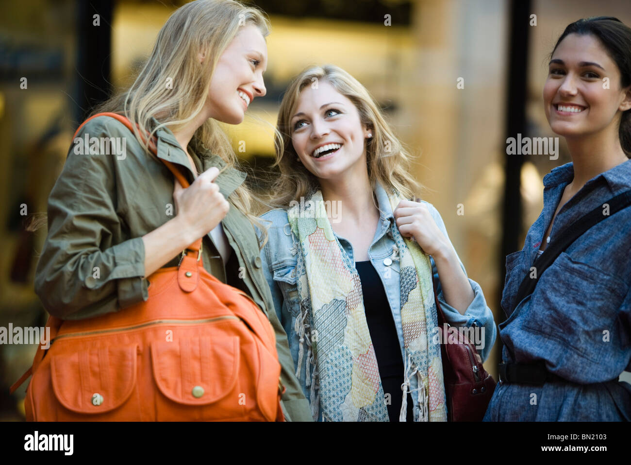 Friends laughing together Stock Photo - Alamy