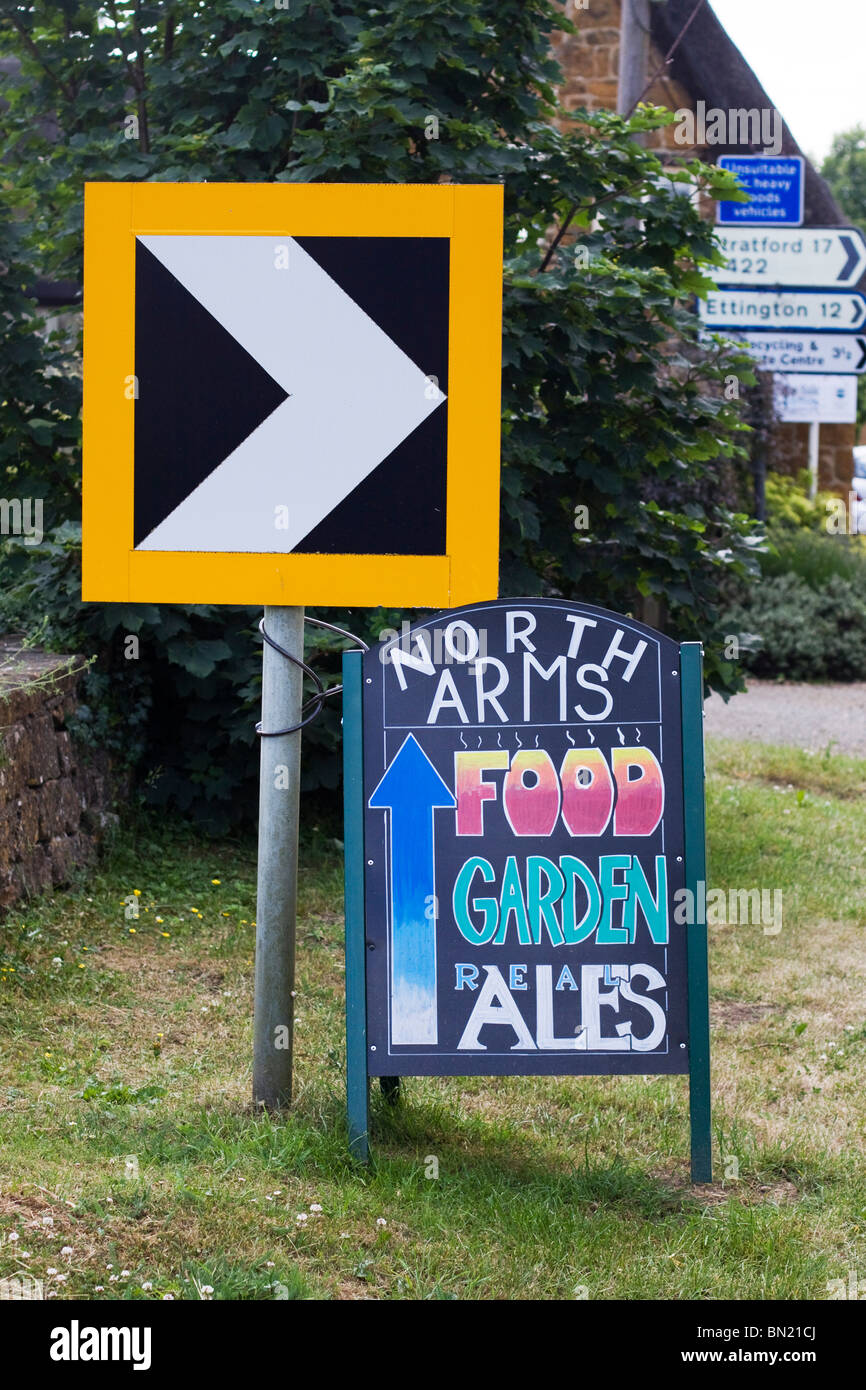 A warning road sign and a pub Advertisement Stock Photo - Alamy