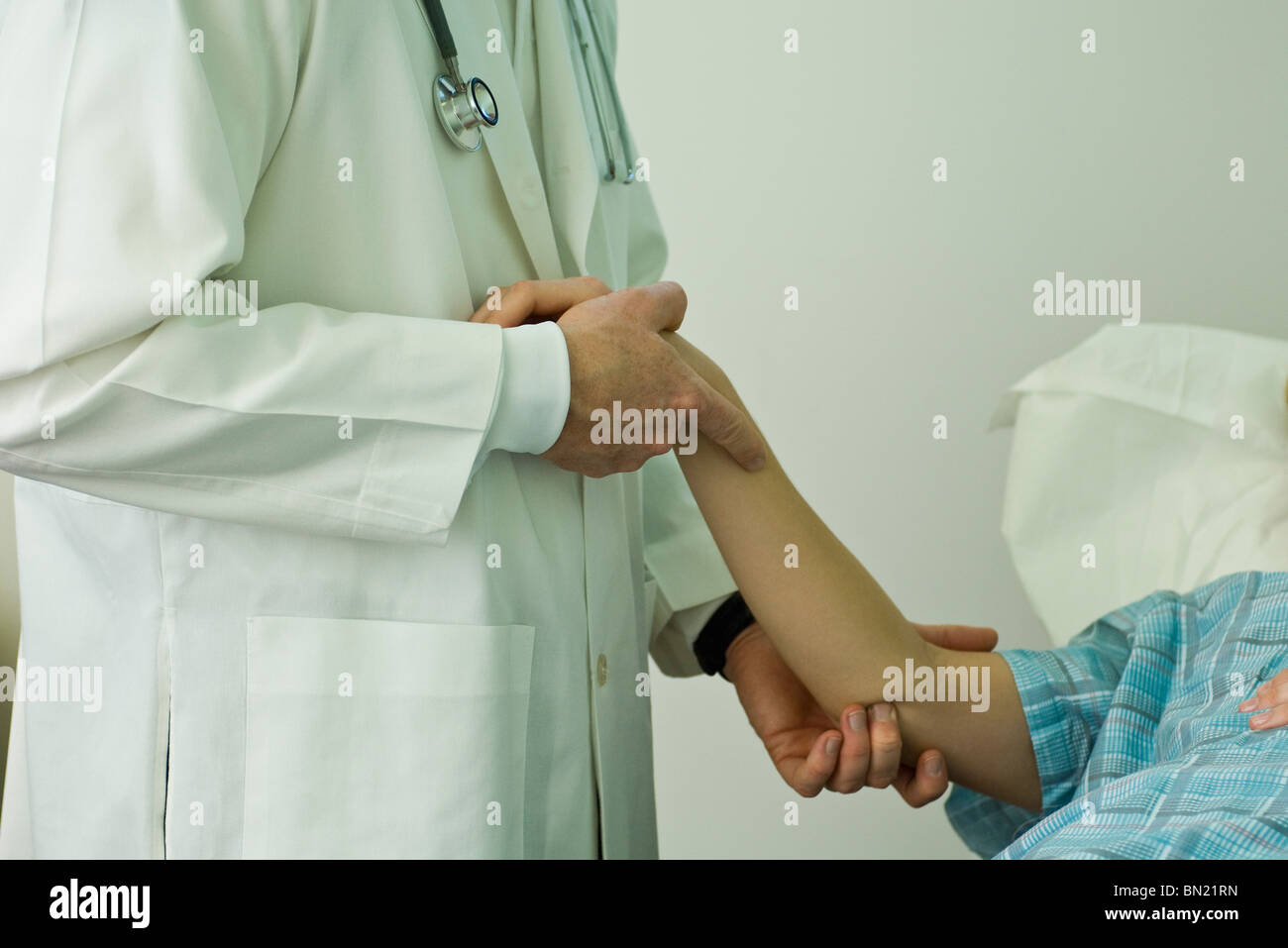 Doctor examining patient's arm Stock Photo - Alamy