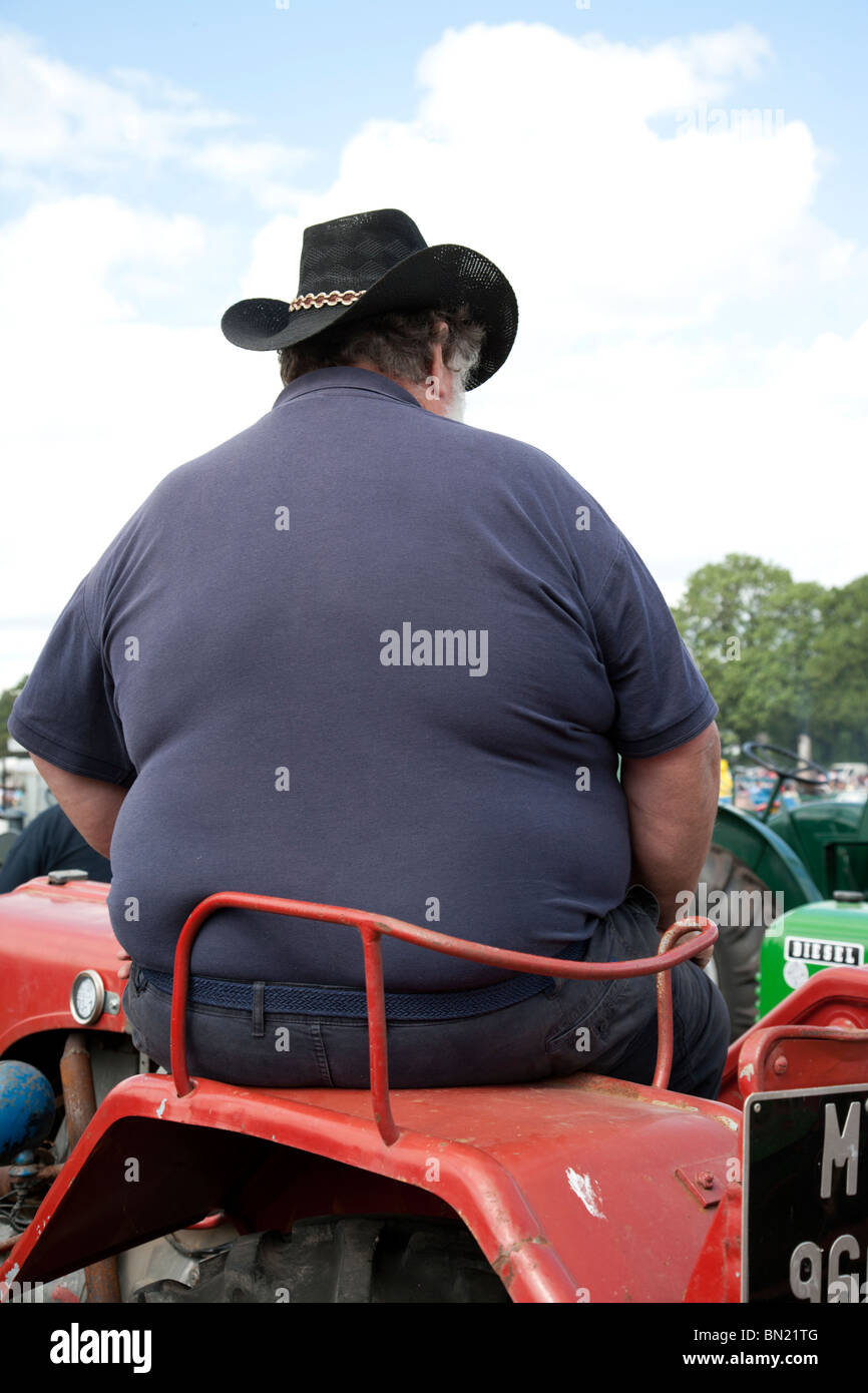 Large man on a tractor, Ireland Stock Photo - Alamy