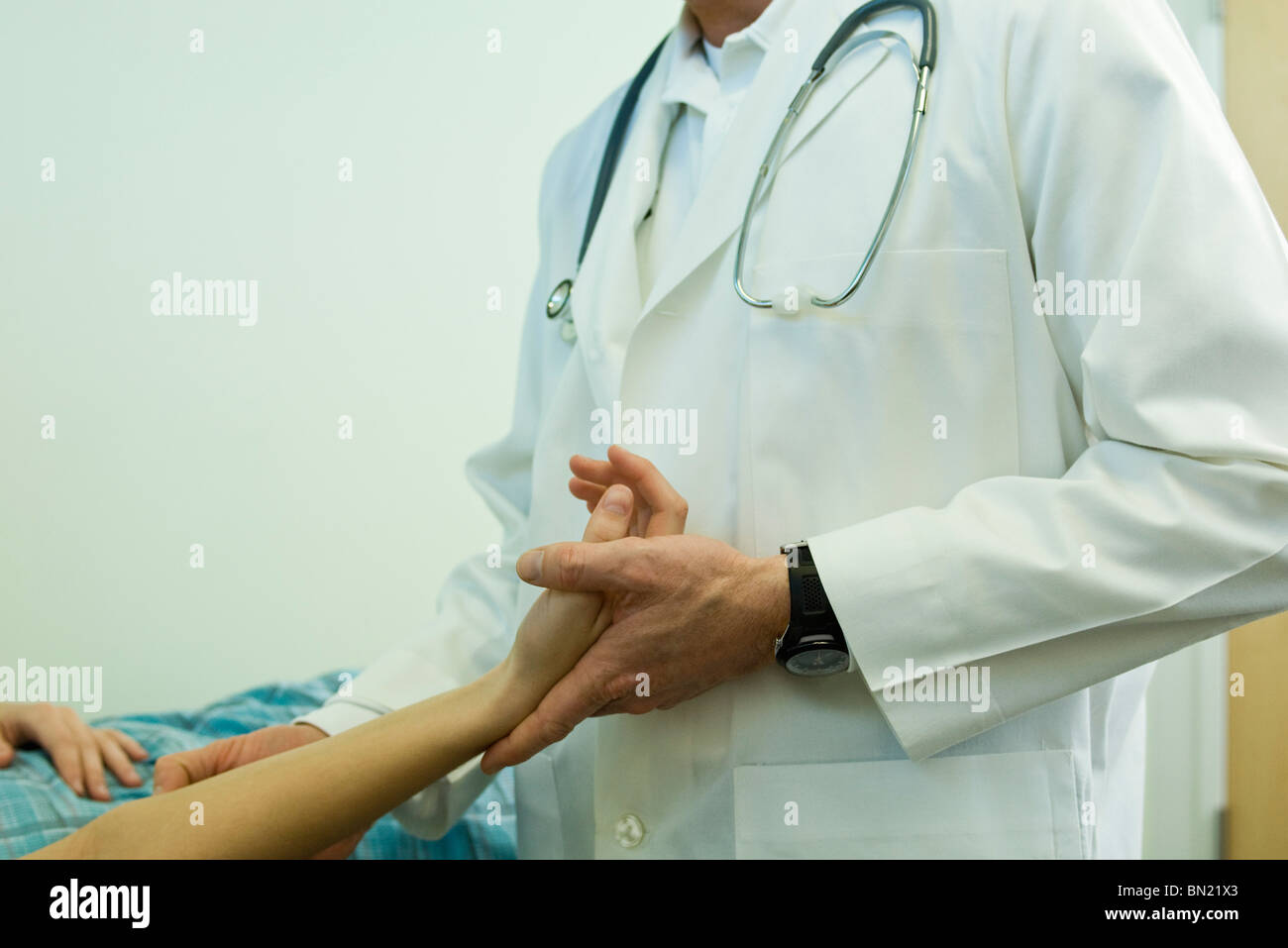Doctor examining patient's arm Stock Photo - Alamy