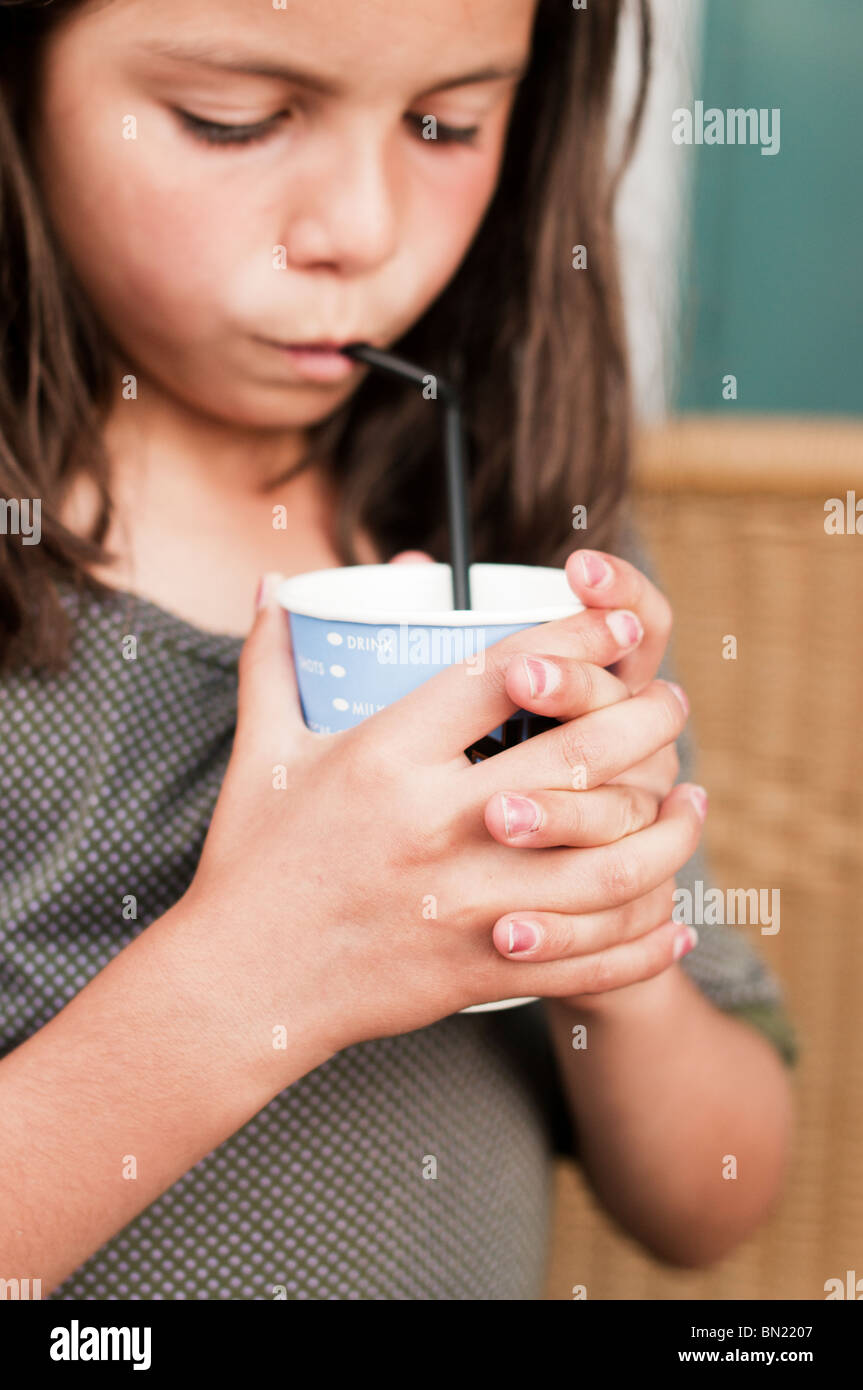 Child drinking with a straw from a paper cup Stock Photo - Alamy