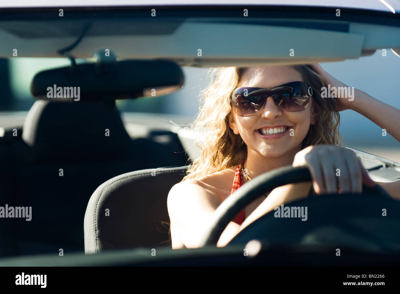 Young woman out for drive on sunny day Stock Photo - Alamy