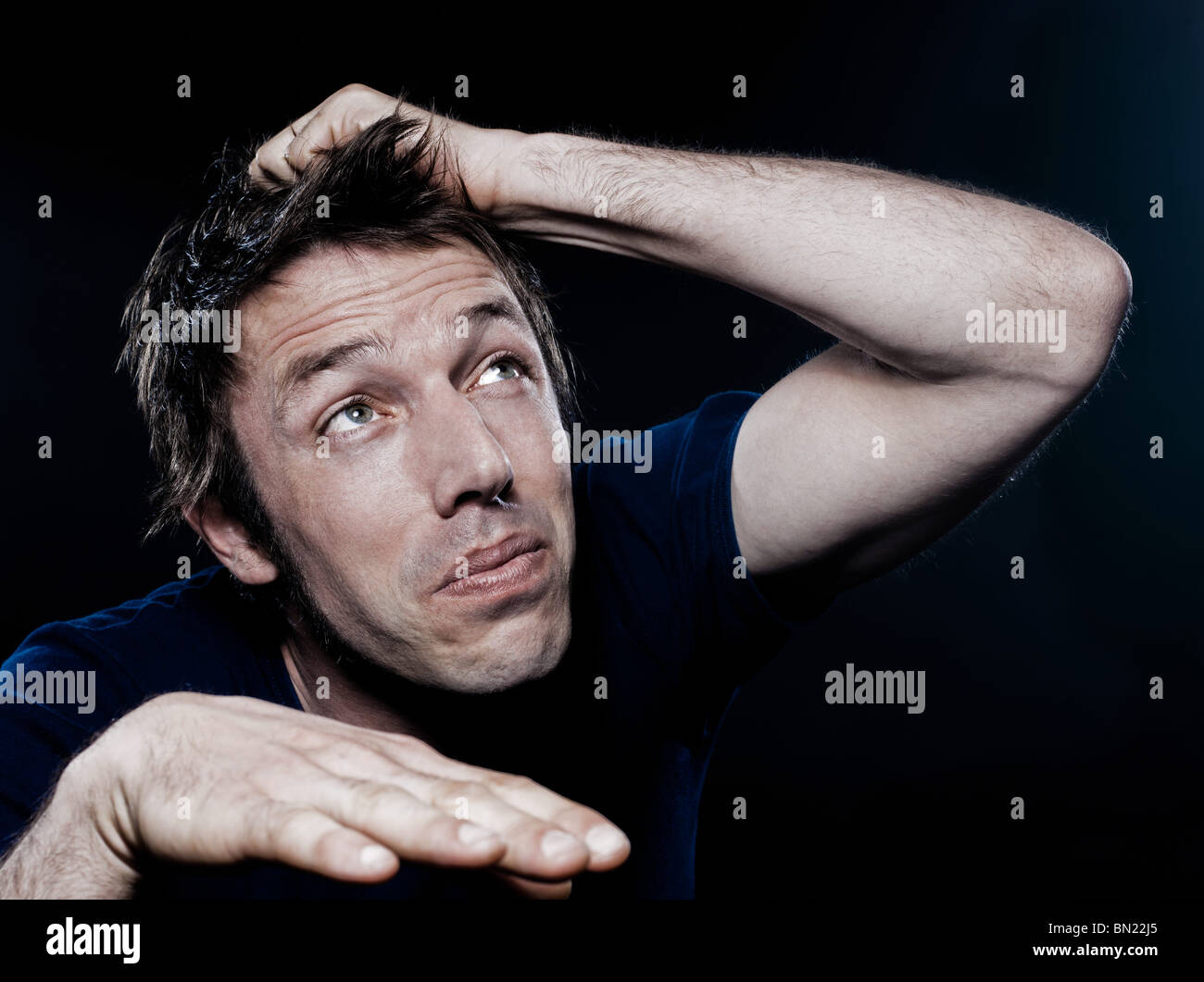 studio portrait on black background of a funny expressive caucasian man ...