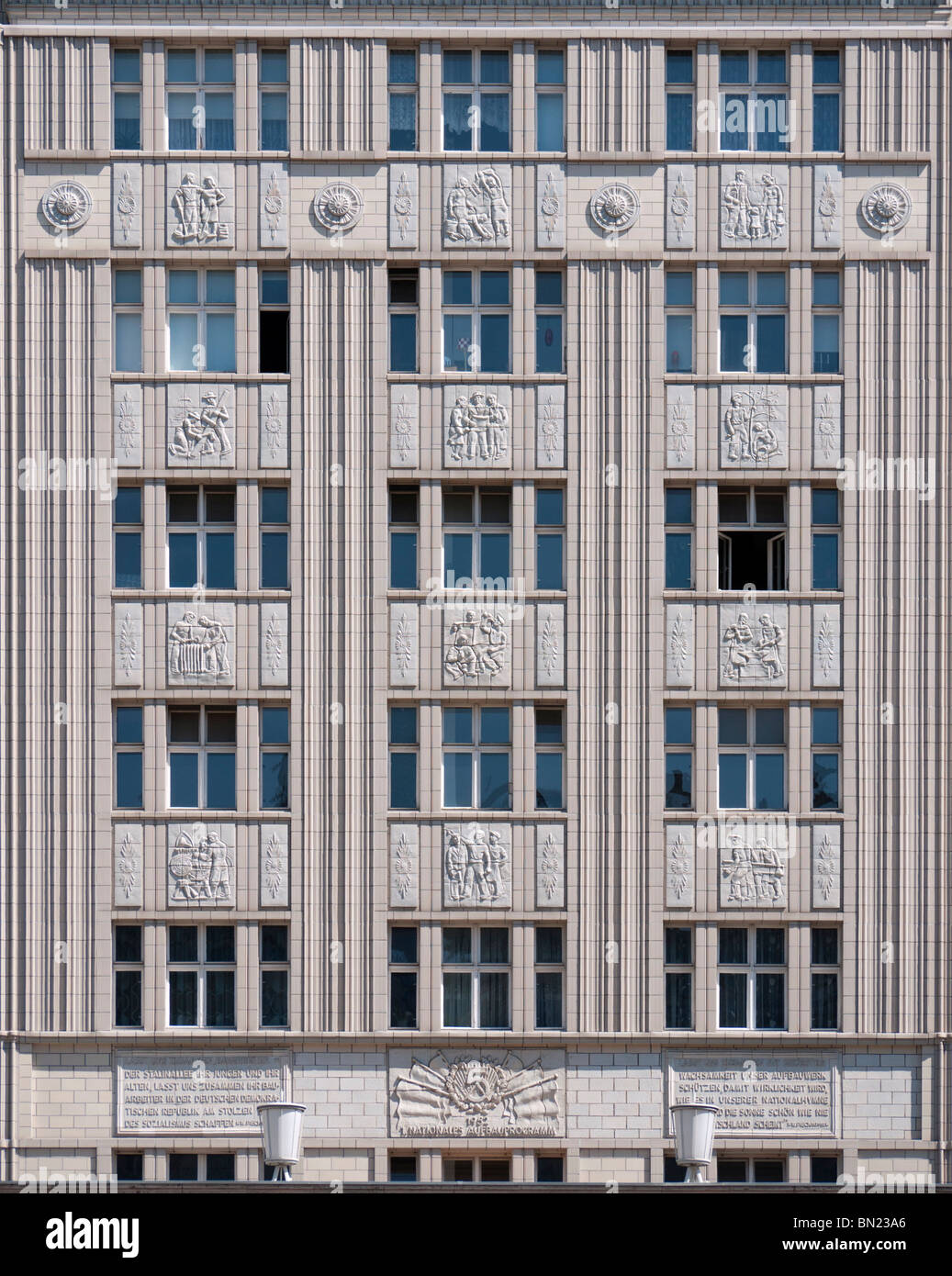 Facades of old socialist GDR era apartment buildings on Karl Marx Allee ...