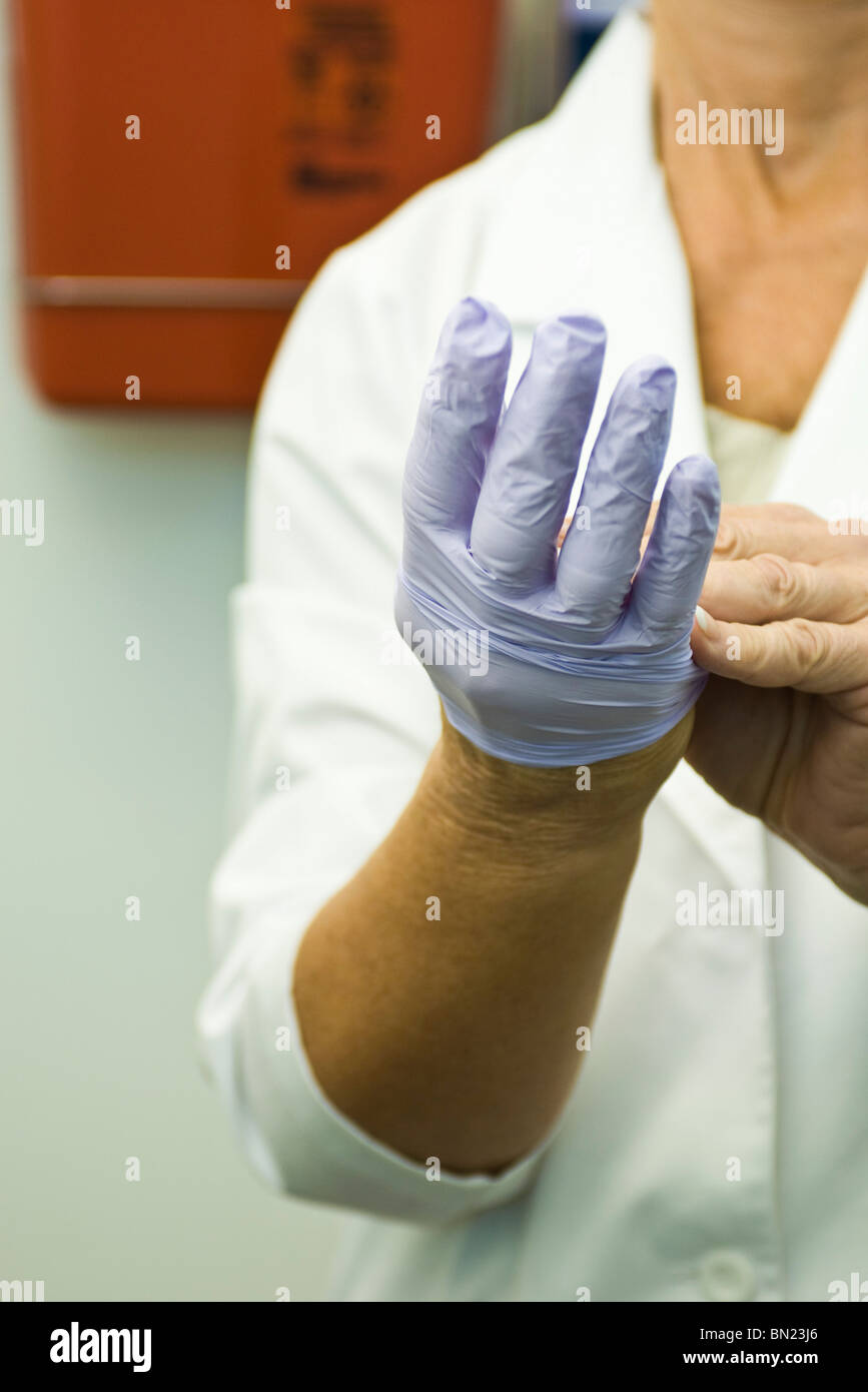 Taking off disposable latex glove Stock Photo - Alamy