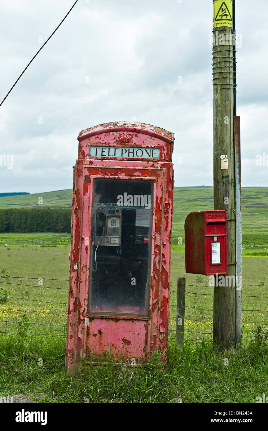 A neglected old red K8 telephone kiosk in the Scottish Borders, next to ...