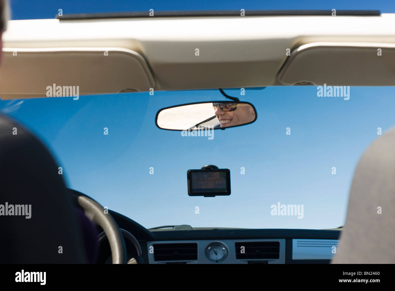 Woman driving car, reflection in rearview mirror Stock Photo - Alamy
