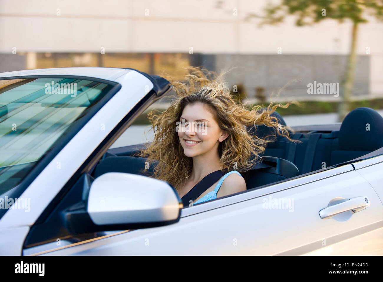 Young woman driving convertible Stock Photo - Alamy