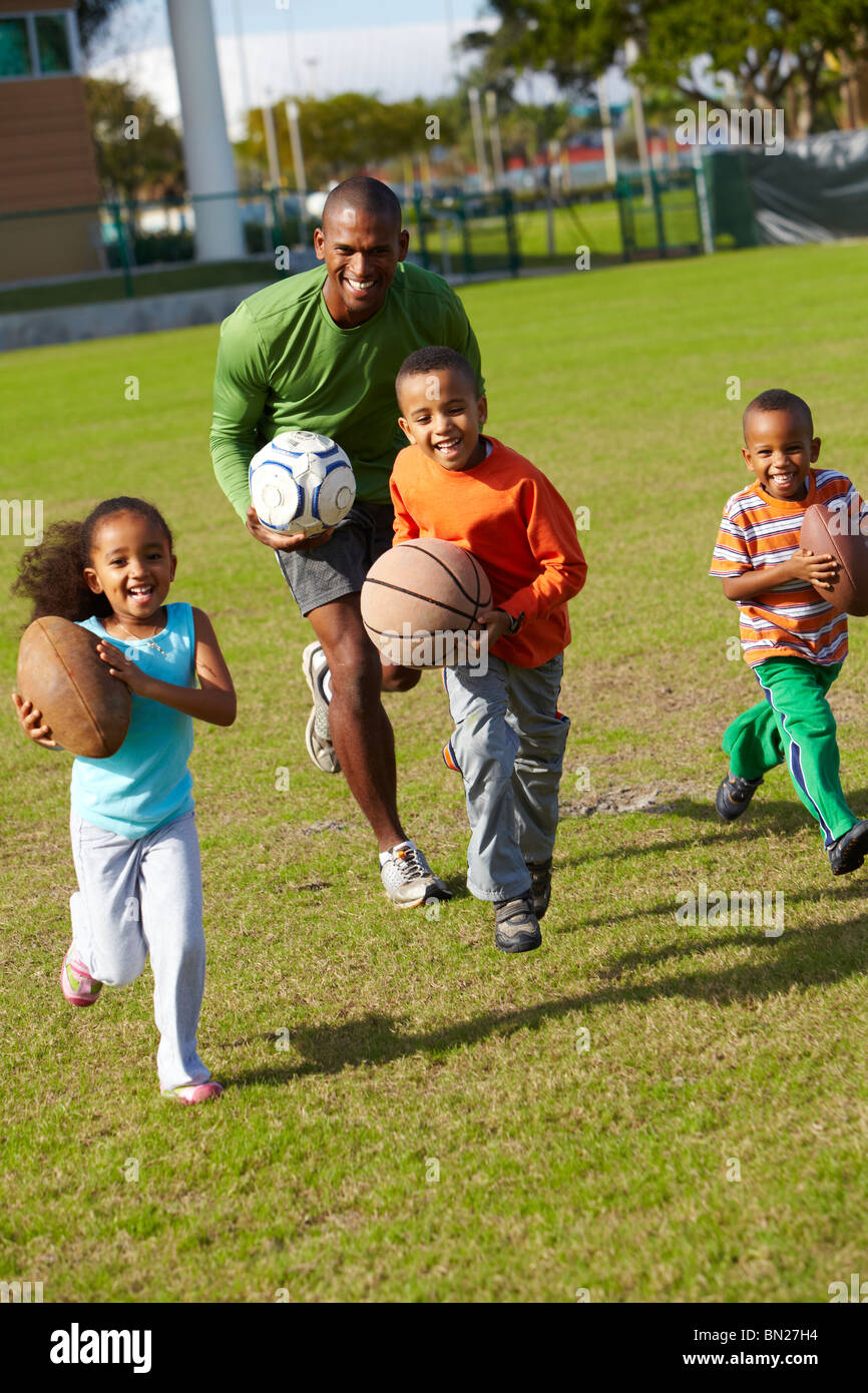 African American father playing ball with children Stock Photo - Alamy