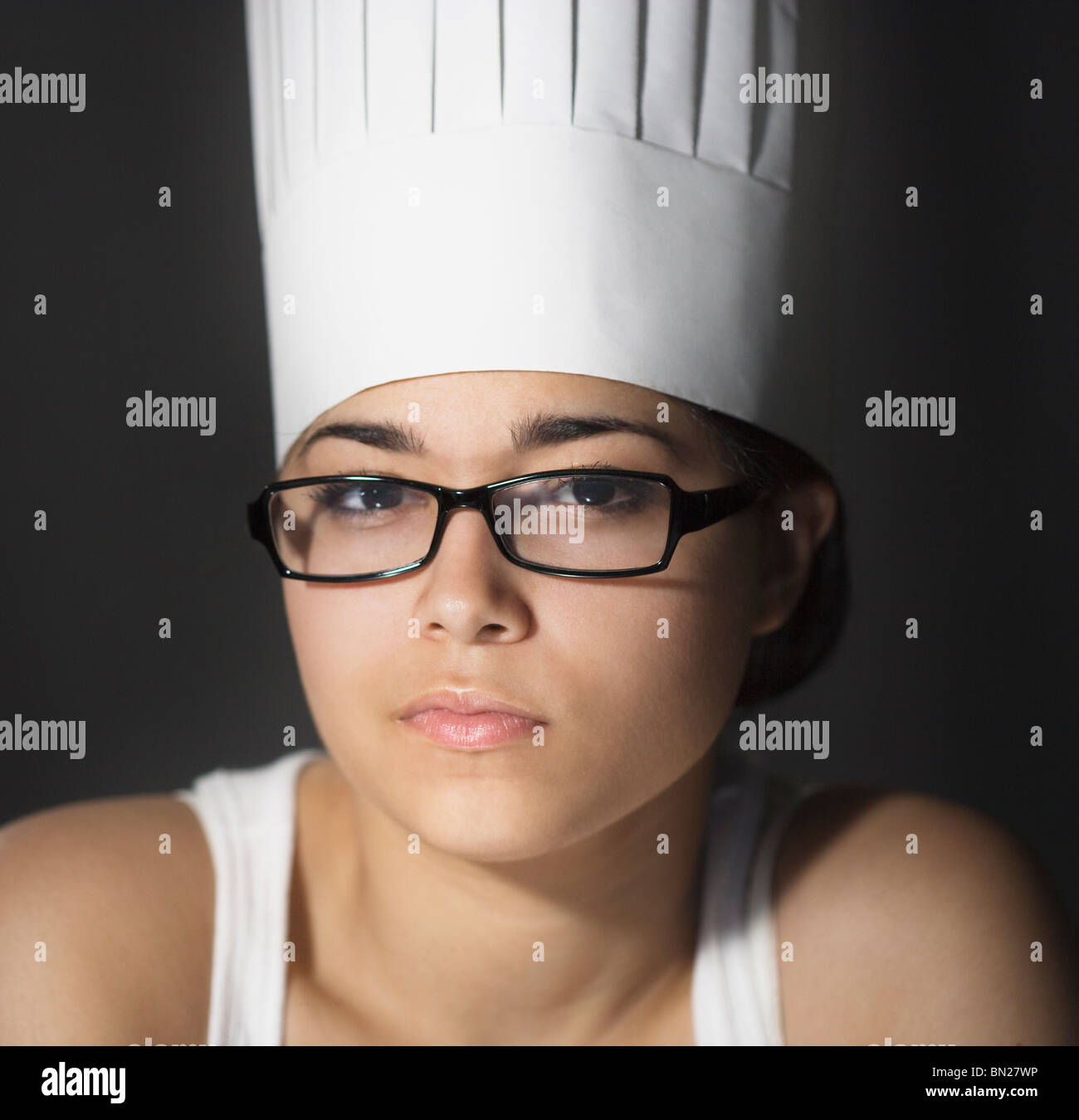 Hispanic woman in chef's hat and eyeglasses Stock Photo - Alamy