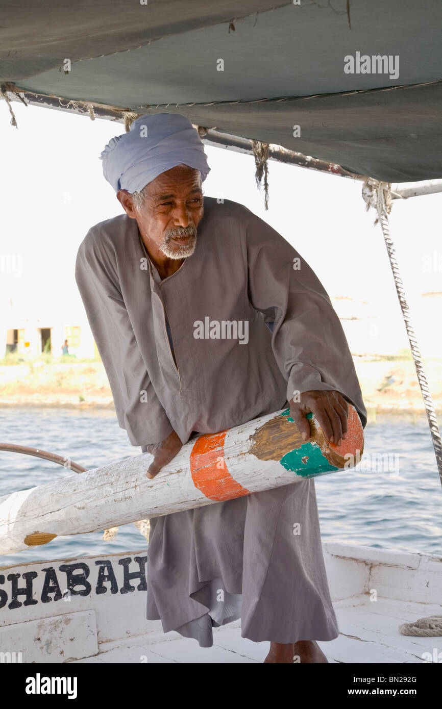 Steering an egyptian feluka boat Stock Photo - Alamy