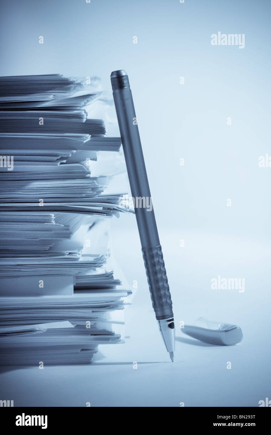 a pen near stack of paper Stock Photo - Alamy