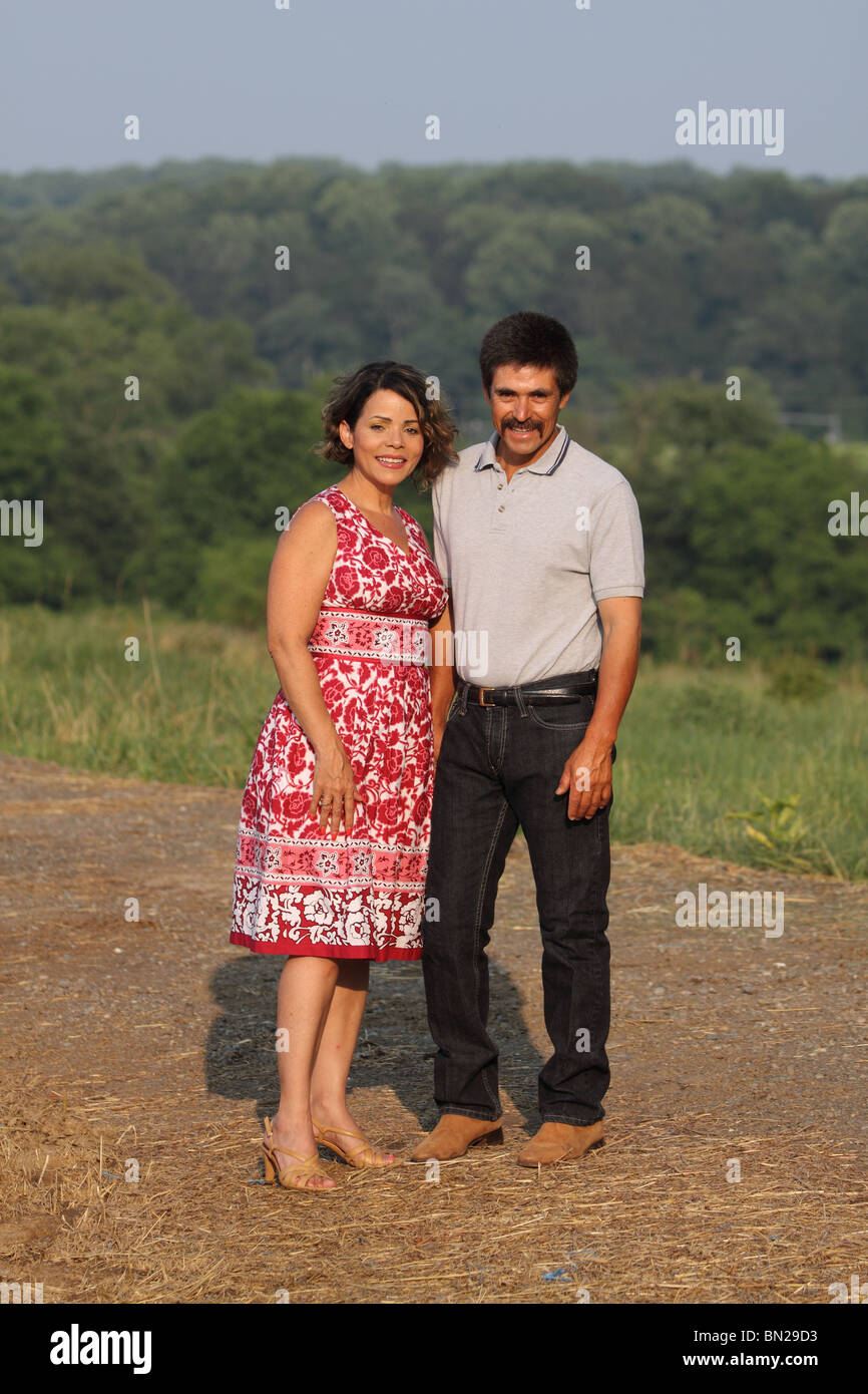 Hispanic couple in the summer talking and laughing Stock Photo - Alamy