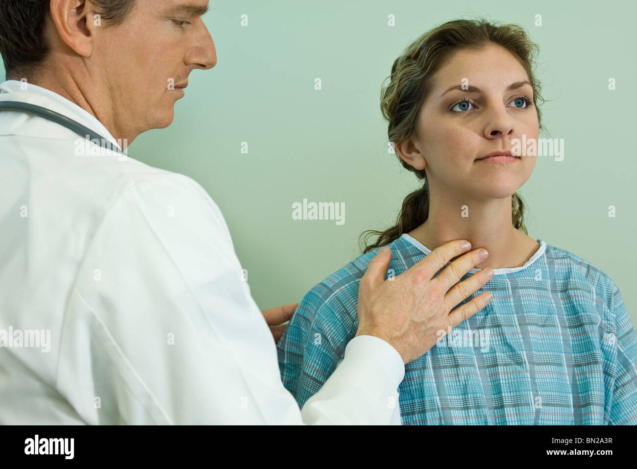 Doctor examining patient's neck glands Stock Photo - Alamy