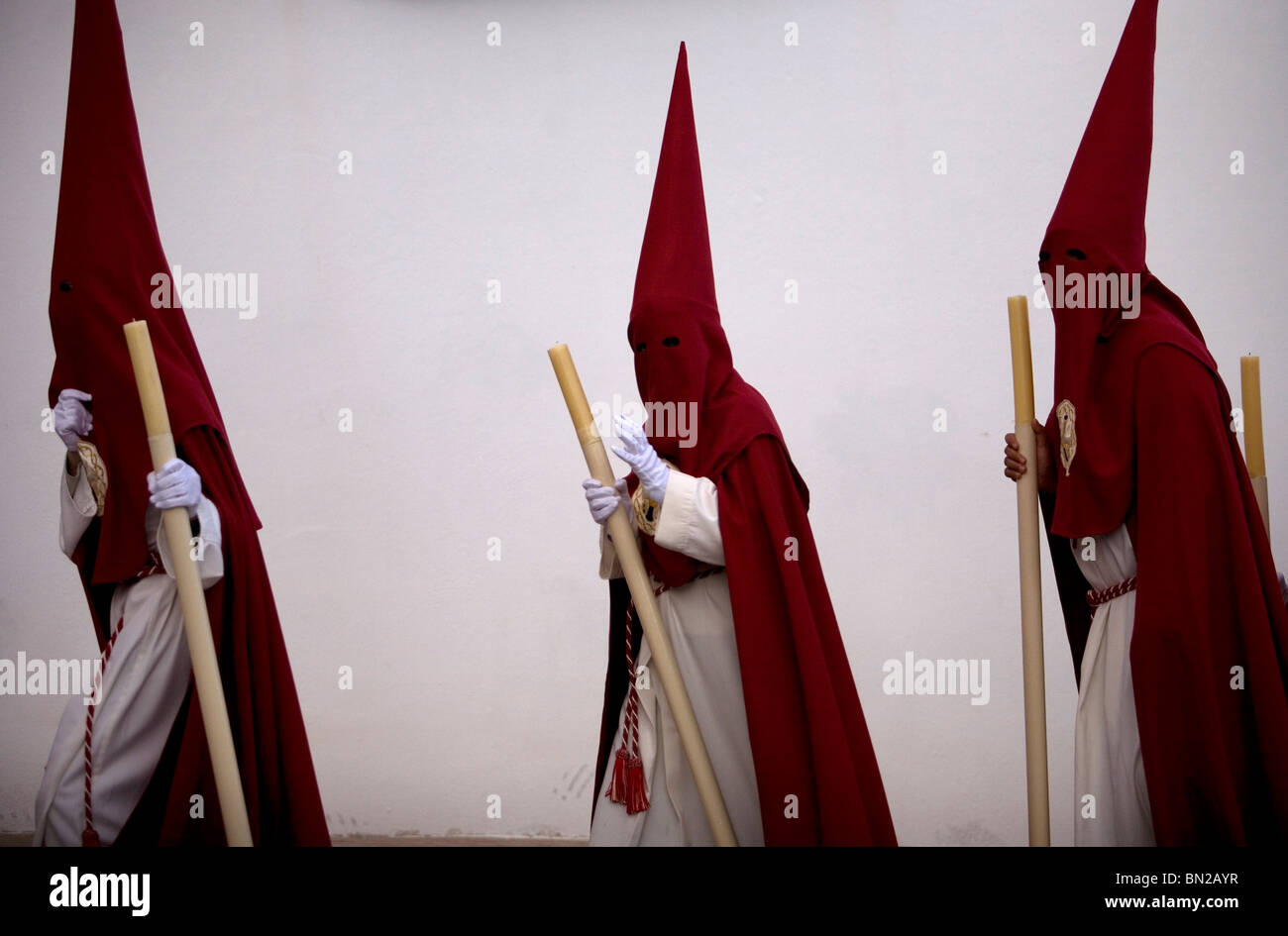 Penitents walk in a street during Easter Holy Week celebrations in ...
