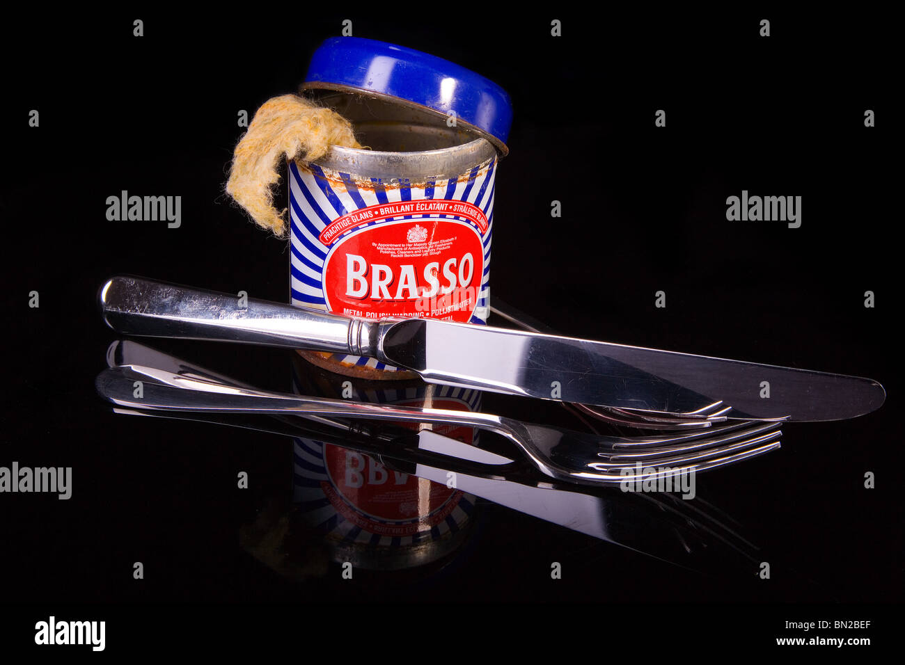 still life of a used tin of Brasso and a knife and fork Stock Photo - Alamy