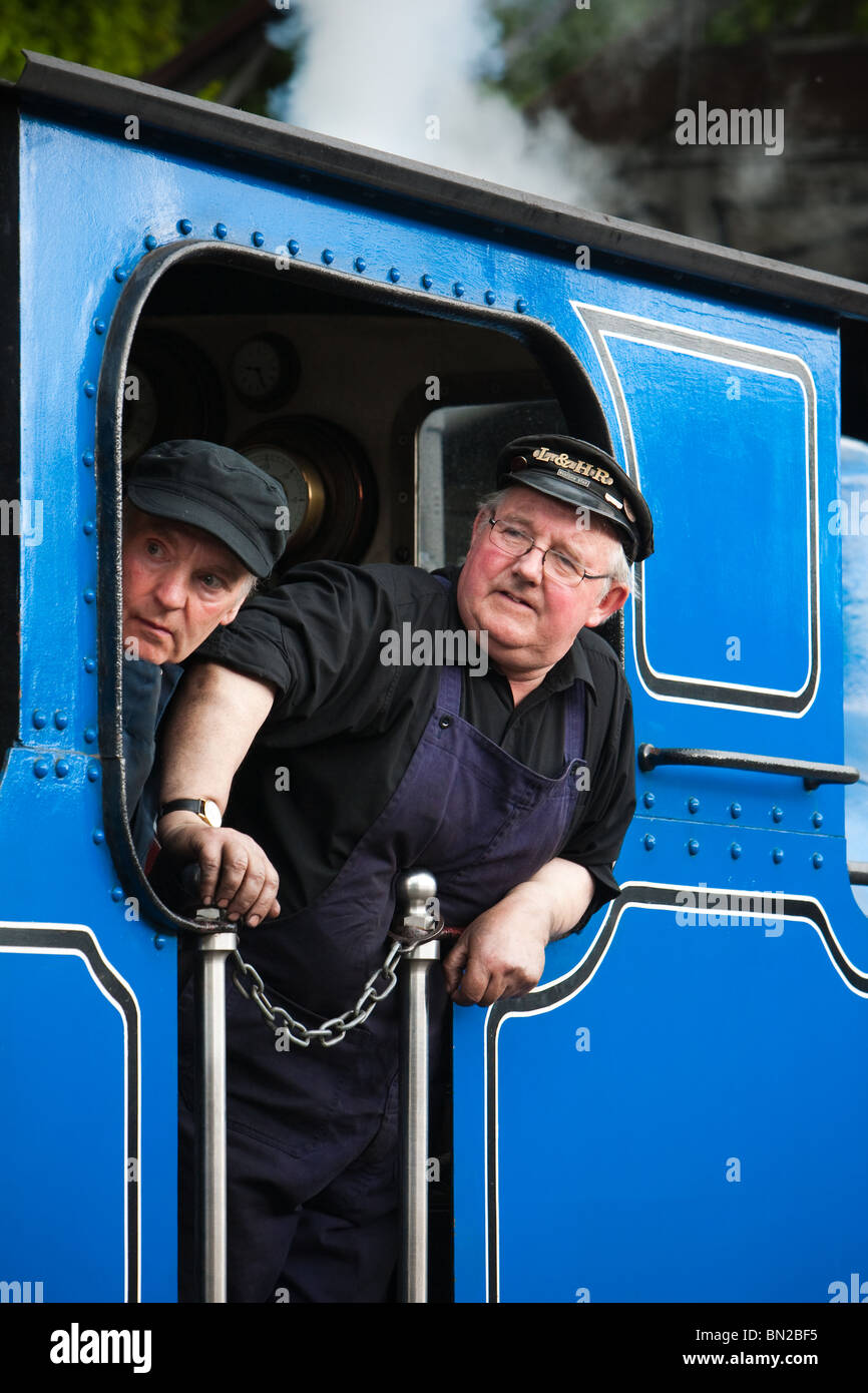 Engine drivers on the steam train leaving Haverthwaite Station on the ...
