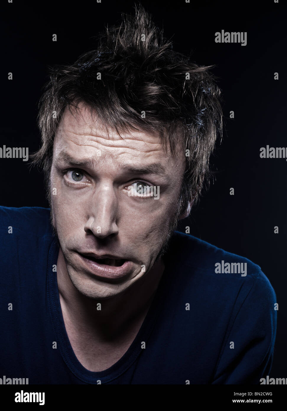 studio portrait on black background of a funny expressive caucasian man ...